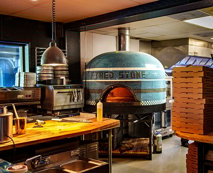 The tiled pizza oven isn't just equipment – it's the beating heart of the kitchen, where smoke and fire transform ingredients into memories.