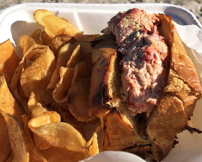 A lobster roll that doesn't need New England's permission to be magnificent—chunky, buttery, and served with no pretense, just potato chips.