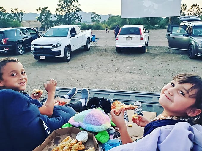 Tailgate dining elevated to an art form—these young moviegoers have mastered the delicate balance of comfort food and comfortable seating.