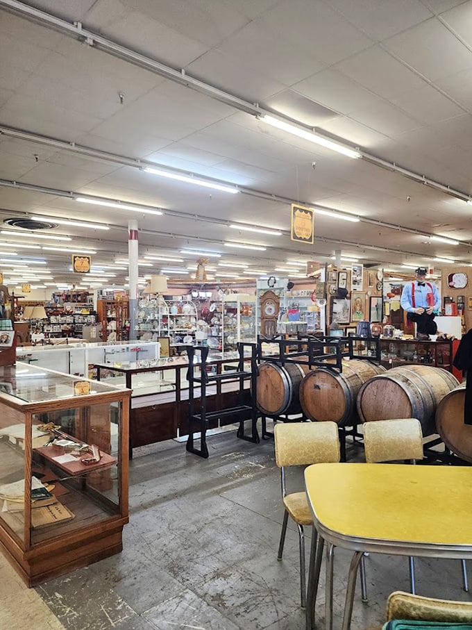 Weathered barrels and display cases create a museum-like corner. The yellow formica table whispers of breakfast nooks and morning coffee from simpler times.