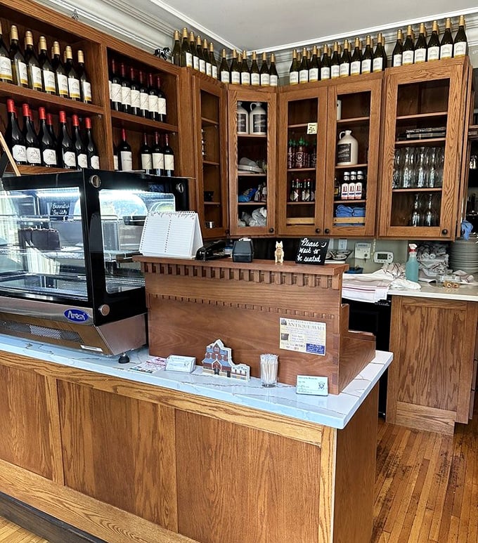 Behind this unassuming counter, liquid treasures await – with bottles standing at attention like soldiers guarding delicious secrets.