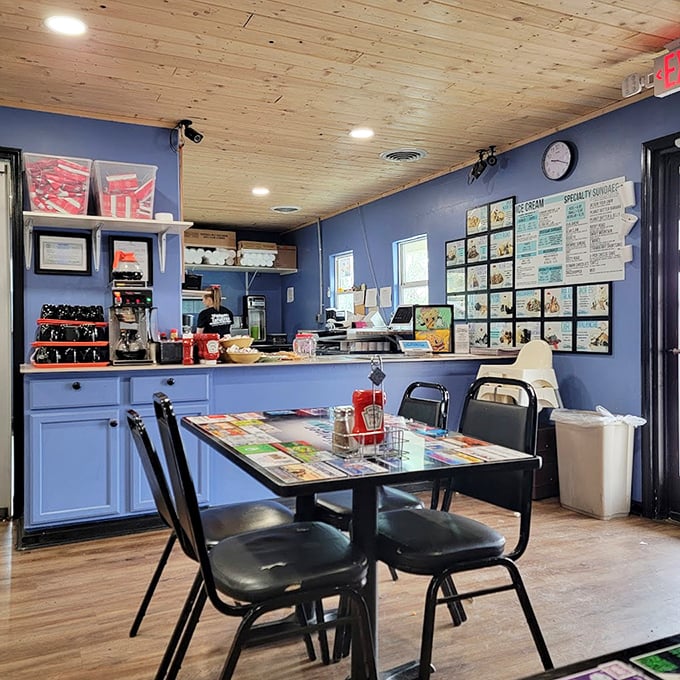 The counter view reveals the command center of comfort food operations—where ice cream dreams and diner classics come to life under warm wooden ceilings.