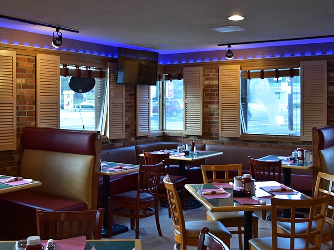 Those blue accent lights aren't just for show—they're setting the mood for serious eating in booths designed for lingering conversations.