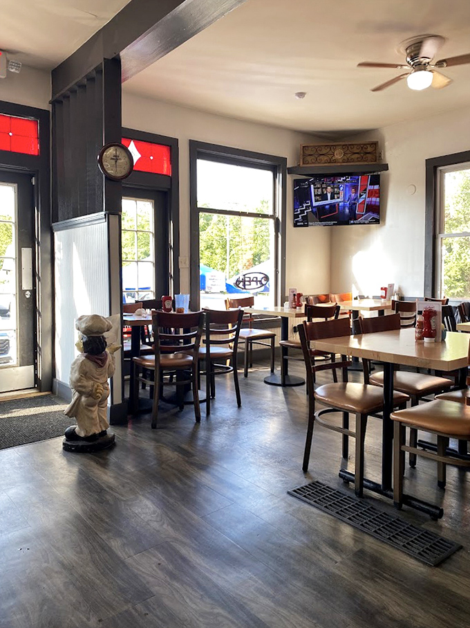 Warm wood tones, natural light, and a chef statue standing guard – dining rooms don't get more inviting than this.