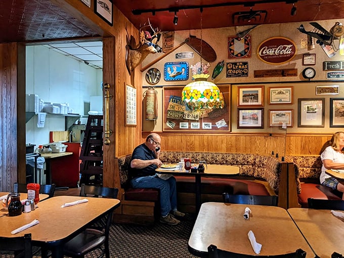 The corner booth – that coveted real estate where regulars hold court and newcomers aspire to sit, under the watchful gaze of vintage memorabilia.