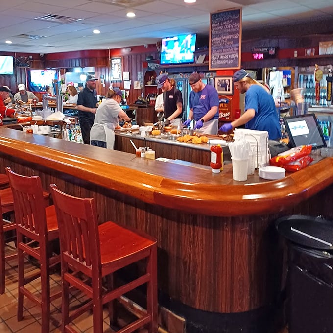 Where magic happens—the bustling bar area where drinks are poured, stories are shared, and strangers become friends over plates of Pennsylvania comfort.
