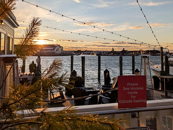Sunset over the water with string lights overhead—Mother Nature's dinner theater. The perfect backdrop for seafood memories in the making.