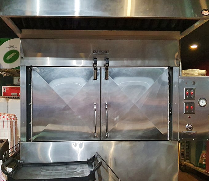 Behind these stainless steel doors, magic happens slowly. The smoker – where patience transforms tough cuts into tender treasures worth waiting for.