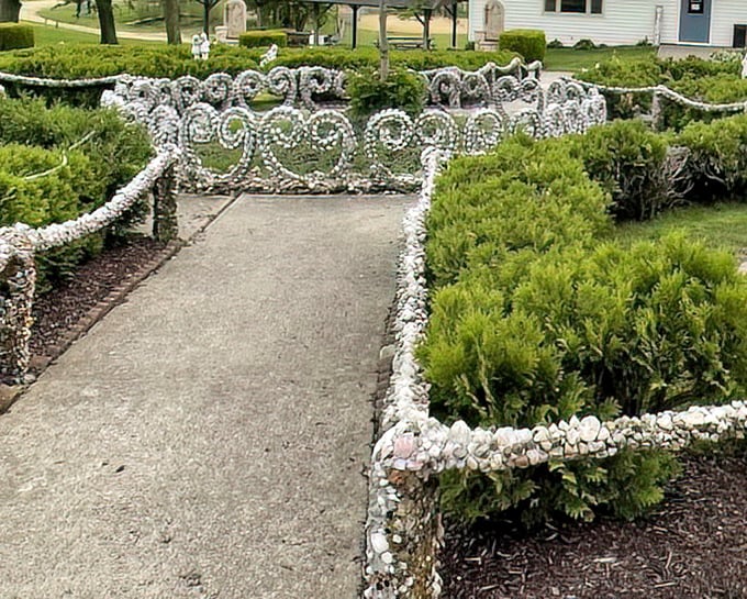 Elegant white stone railings curve alongside manicured hedges—formal garden design with a distinctly Midwestern sparkle.