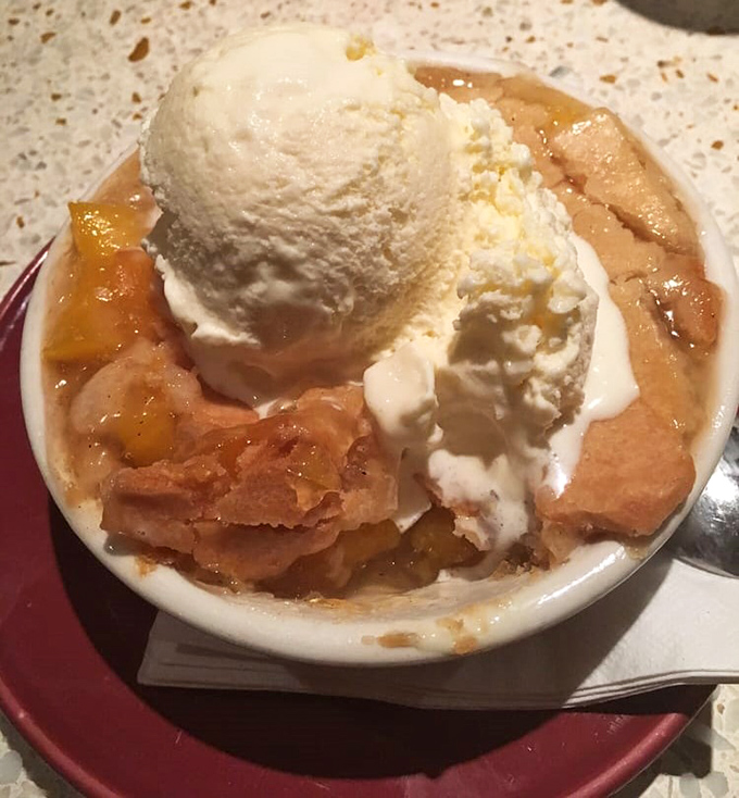 Peach cobbler à la mode that makes you wonder why you ever waste calories on trendy desserts when classics like this exist.