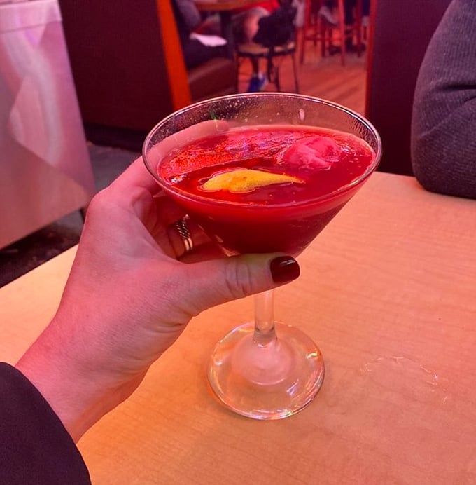 This isn't just a cocktail—it's a ruby-red jewel in a glass that promises to make whatever story you're telling your friends 40% more interesting.