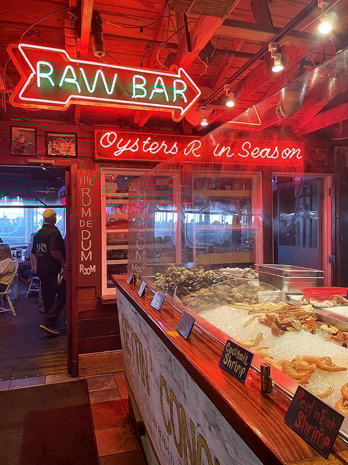 The neon-lit raw bar promises oceanic treasures on ice. Like a seafood jewelry counter where the gems are edible and deliciously briny.