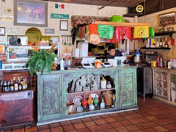 The heart of the operation—where colorful papel picado banners hang above a counter that's seen thousands of happy customers come and go.