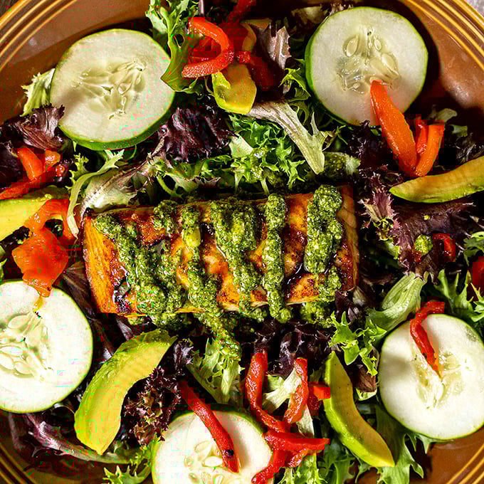 Fresh greens topped with grilled protein – proof that tavern food doesn't always mean guilty pleasures.