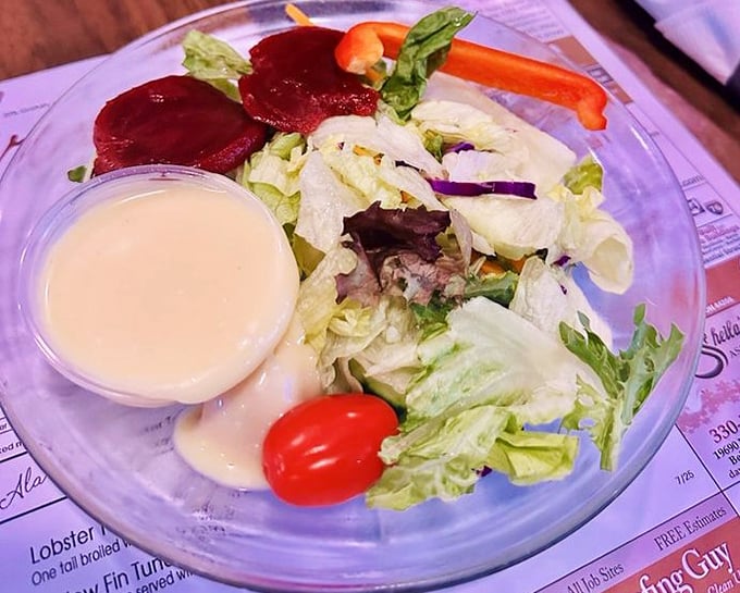 A house salad that knows its role – fresh, crisp, and just enough to make you feel virtuous before the meat parade begins.