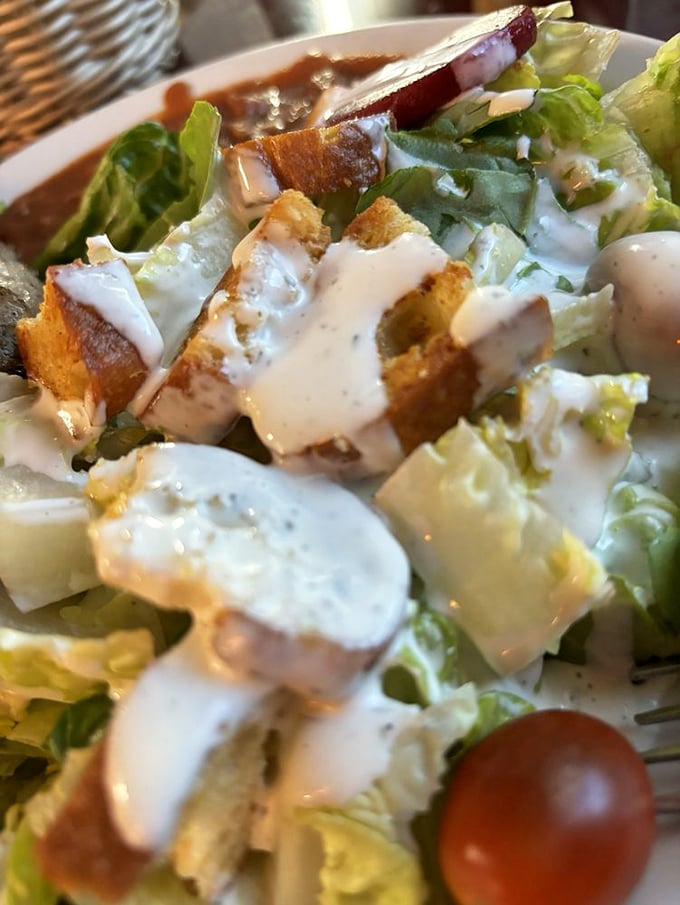 Even the salad gets the respect it deserves—crisp greens, house-made dressing, and croutons that crunch like they mean business.