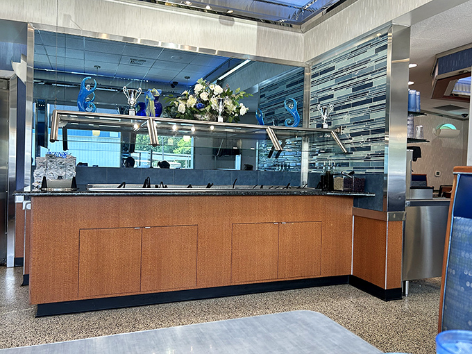 The service counter gleams with pride, its wood paneling and blue accents creating that perfect backdrop for the parade of comfort food heading to hungry tables.