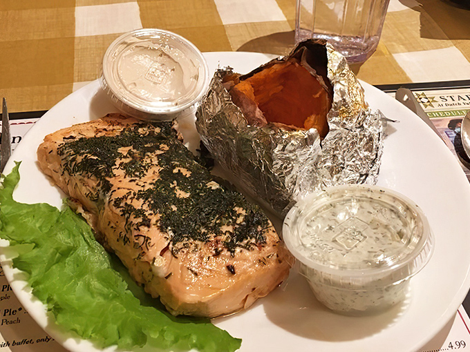 Herb-crusted salmon that looks like it swam upstream just to meet that perfectly foil-wrapped baked potato—a romance for the ages.