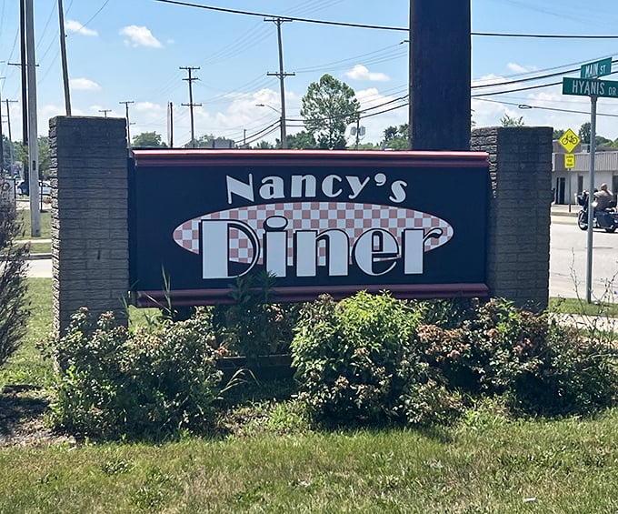 The sign announces Nancy's presence like a friendly neighbor. Classic diner typography that promises good food without pretension or wallet pain.
