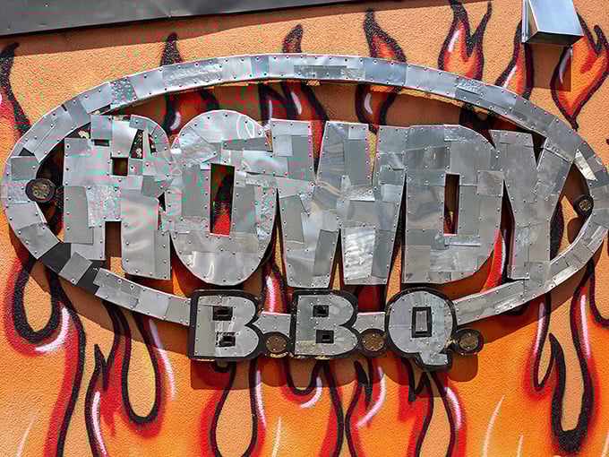 The metal Rowdy BBQ sign against flames is like a bat signal for hungry people. When you see this, your taste buds know they're about to have a very good day.