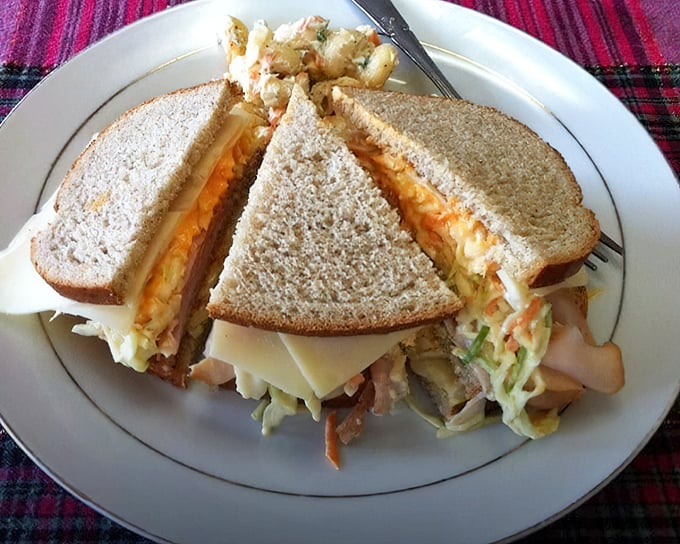 This sandwich isn't messing around. Layers of meat and cheese pressed between toasted bread create the kind of lunch that requires a nap afterward—in the best possible way.
