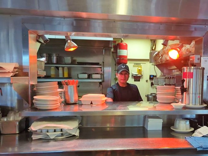 The kitchen crew throwing peace signs like they just won the breakfast Olympics – and honestly, they might have.