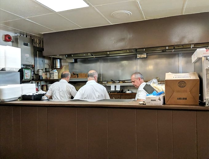 The kitchen maestros in their element – three breakfast conductors orchestrating the morning symphony of sizzles and flips.