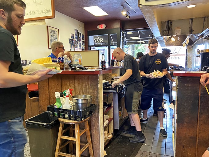 The sandwich artists at work—choreographing the ballet of bread, meat, and cheese. These are the hands that feed Pittsburgh's soul.