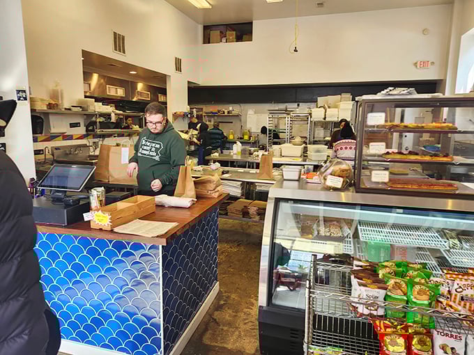 Behind the blue-tiled counter, sandwich artisans work their magic, transforming simple ingredients into edible masterpieces that keep Philly coming back.