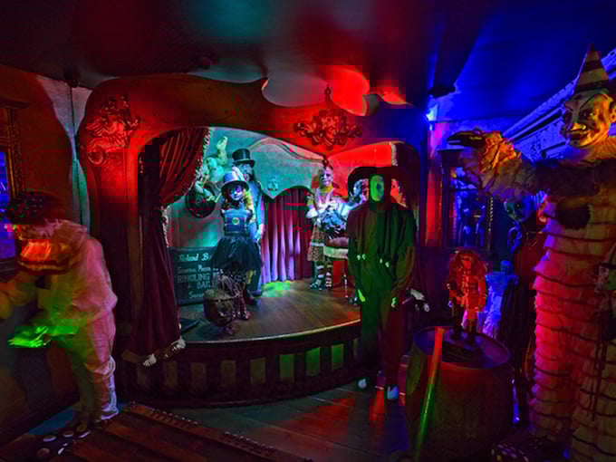 These colorful carnival figures look like they're performing for an audience that departed decades ago but never quite left the building.