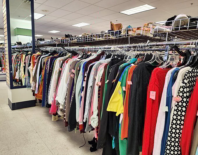 The rainbow of hanging garments isn't just clothing—it's potential identities waiting to be adopted for less than a fancy coffee.