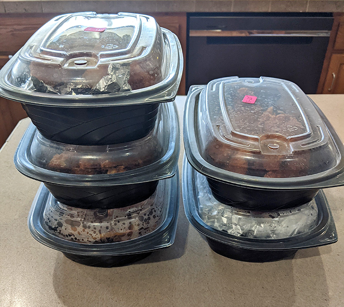 To-go containers stacked like trophies of delicious defeat—proof that BillBoard Bistro's portions believe in generosity as a core value.