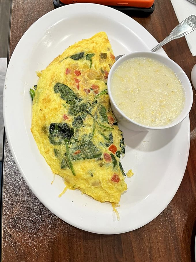 A veggie omelet that makes eating greens before noon feel like an indulgence rather than virtue. The side of grits isn't optional—it's destiny.