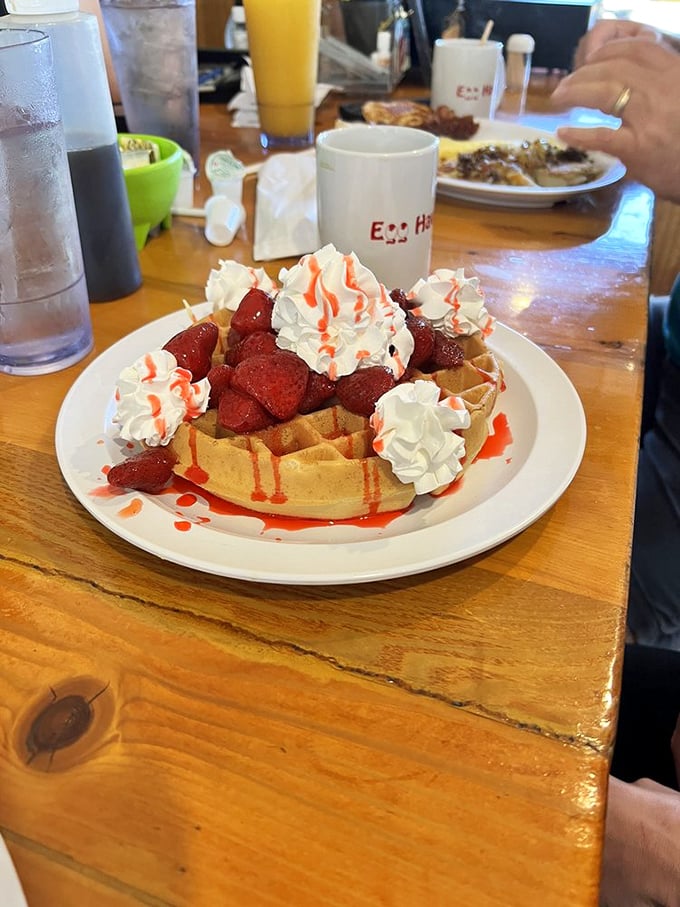 Waffle nirvana: crisp edges, tender center, crowned with strawberries and whipped cream – dessert masquerading as breakfast and fooling no one.