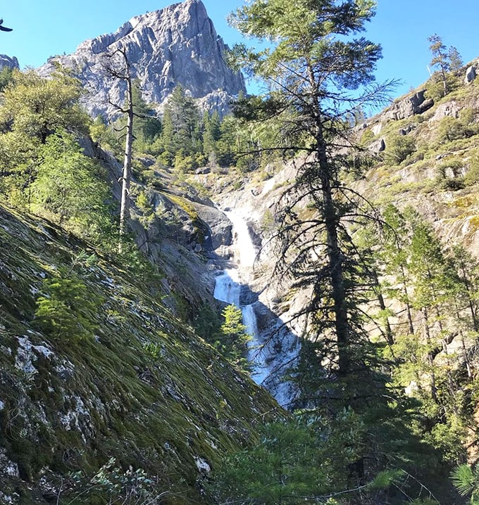 A hidden waterfall cascades down the mountainside, providing nature's soundtrack. The perfect reward for hikers willing to venture beyond the obvious paths.
