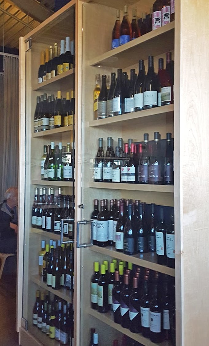 The wine selection stands ready like a liquid library, with bottles that have been carefully curated to complement the ocean's finest offerings.