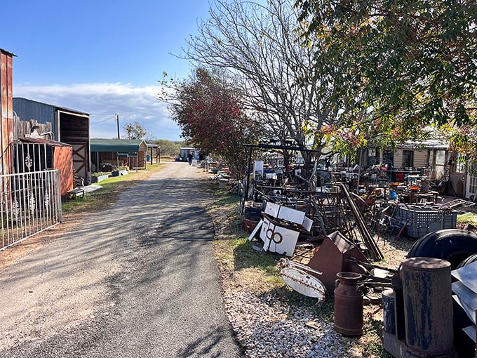 Rust never sleeps! This pathway between vendors reveals that even old farm equipment can become someone's perfect garden decoration.