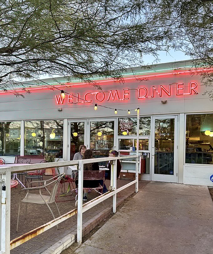 The glowing neon of Welcome Diner at dusk – where Phoenix's food scene shines as bright as the desert stars.