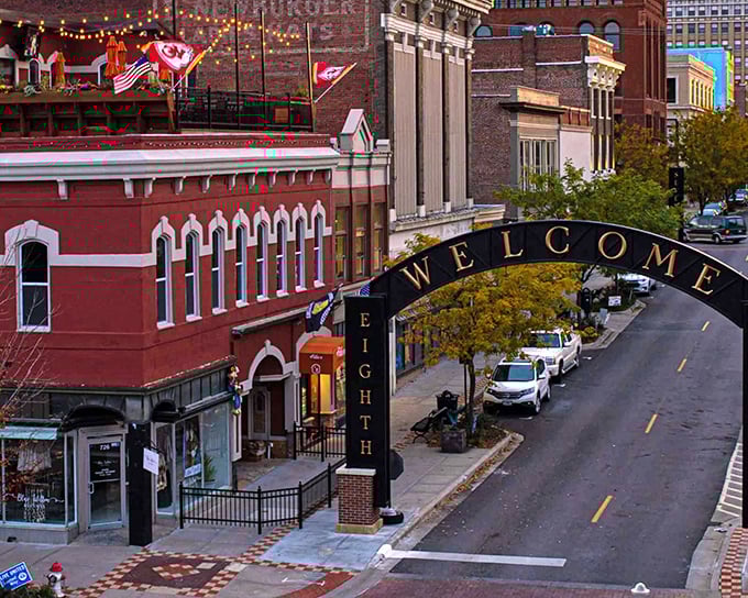 The Welcome Arch glows against an autumn sunset, while Kansas City Chiefs flags flutter proudly above—hometown pride comes in many forms here.