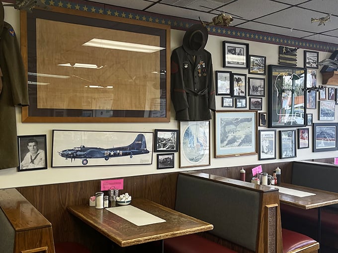 Every booth tells a story, while model planes overhead remind you why this place earned its high-flying name.