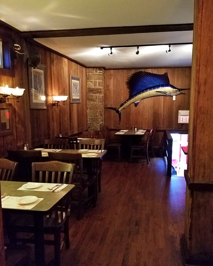 Wood-paneled walls, mounted sailfish, and simple tables create an atmosphere where the food—not the decor—rightfully takes center stage.