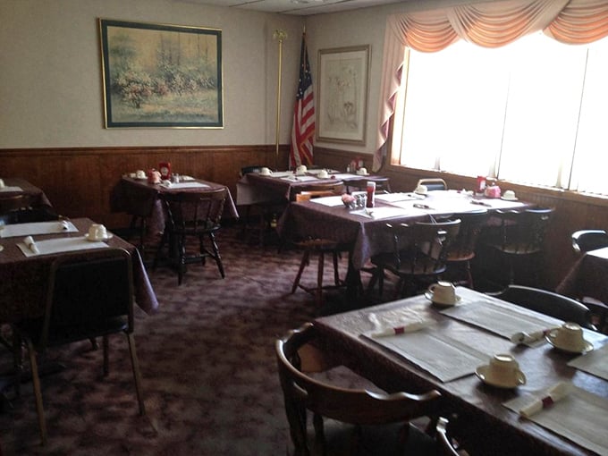 The dining room's patriotic corner – where American flags and pastoral art remind you that diners are as quintessentially American as baseball and complaining about taxes.