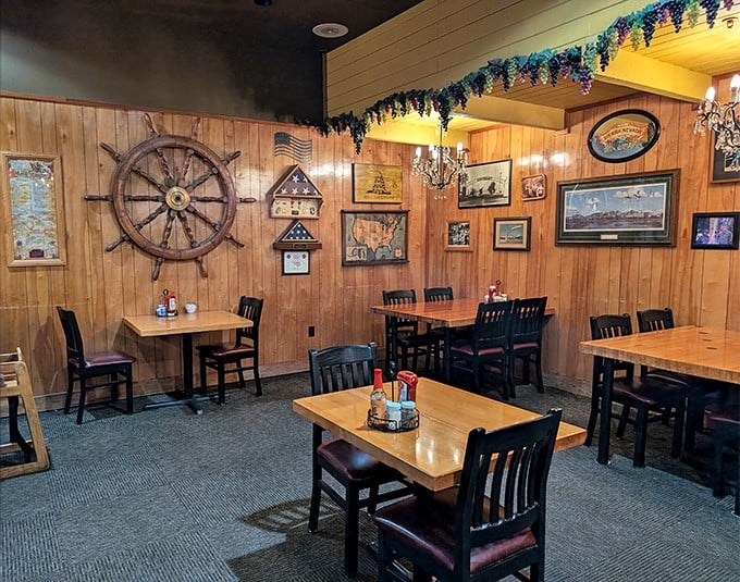 Nautical meets rustic in this dining area where a ship's wheel watches over tables of hungry patrons. The wood-paneled walls whisper tales of meals past.