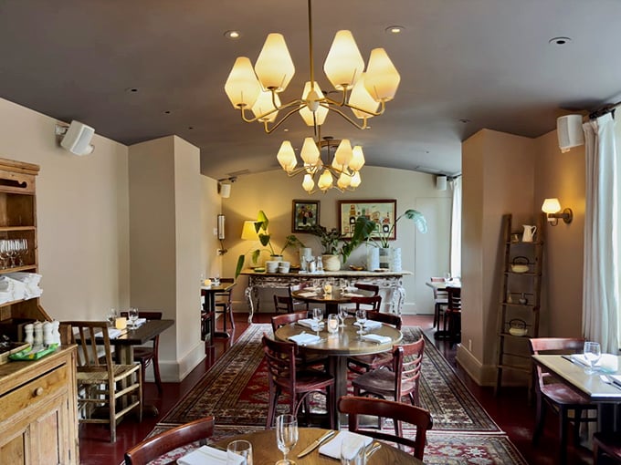 Another dining room reveals a different personality – elegant chandeliers, oriental rugs, and tables set for memorable conversations.