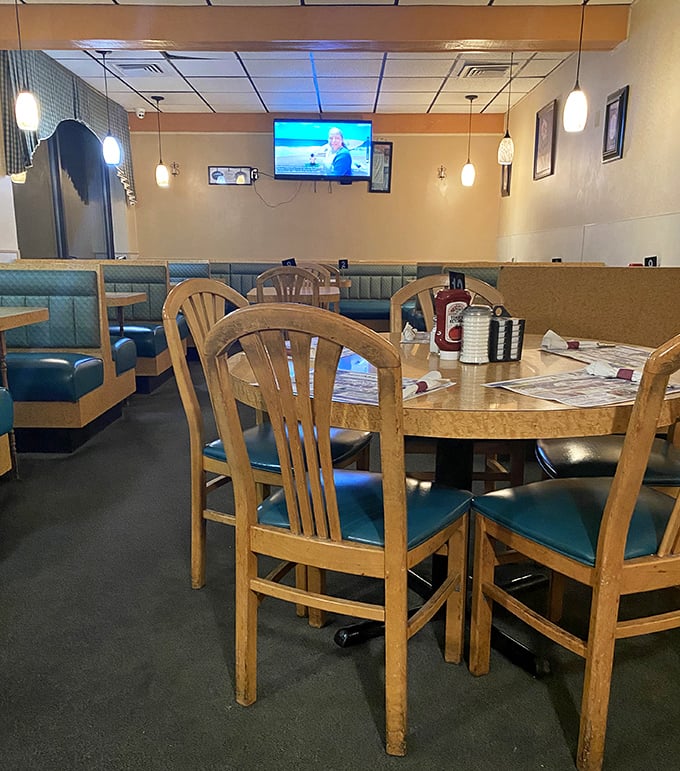 Wooden chairs and teal upholstery create the backdrop for countless family meals, first dates, and morning-after recovery breakfasts.