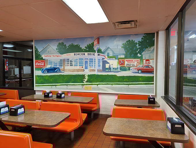 Wall murals preserving The Beacon's storied past. Orange booths and vintage vibes—some things are too perfect to change.