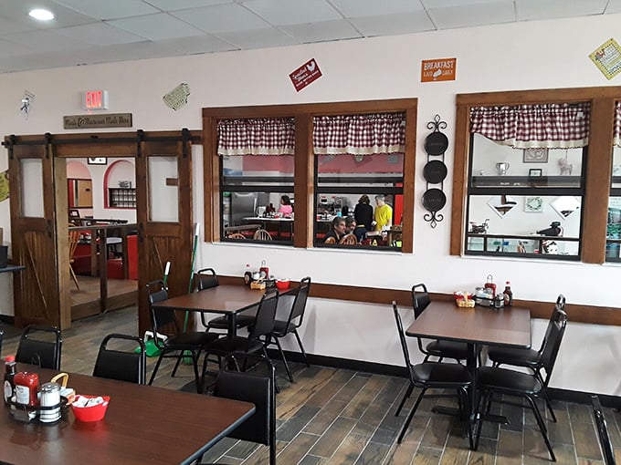 Simple tables, checkered curtains, and sliding barn doors – a dining room that feels like your favorite aunt's kitchen, only with better food.