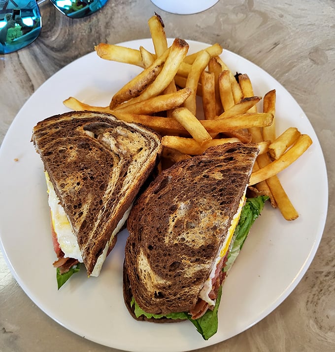 A sandwich that understands the assignment – perfectly toasted bread, crisp lettuce, and that added fried egg that transforms good into unforgettable.