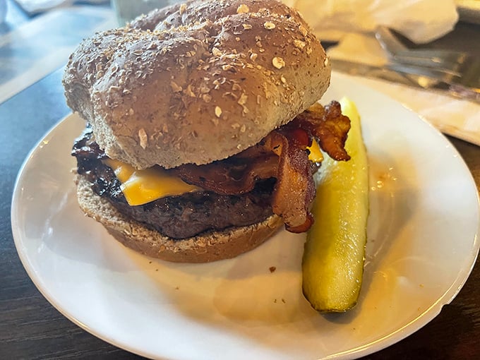 A burger that requires both hands and possibly a strategy meeting. That pickle spear isn't just garnish—it's necessary balance!