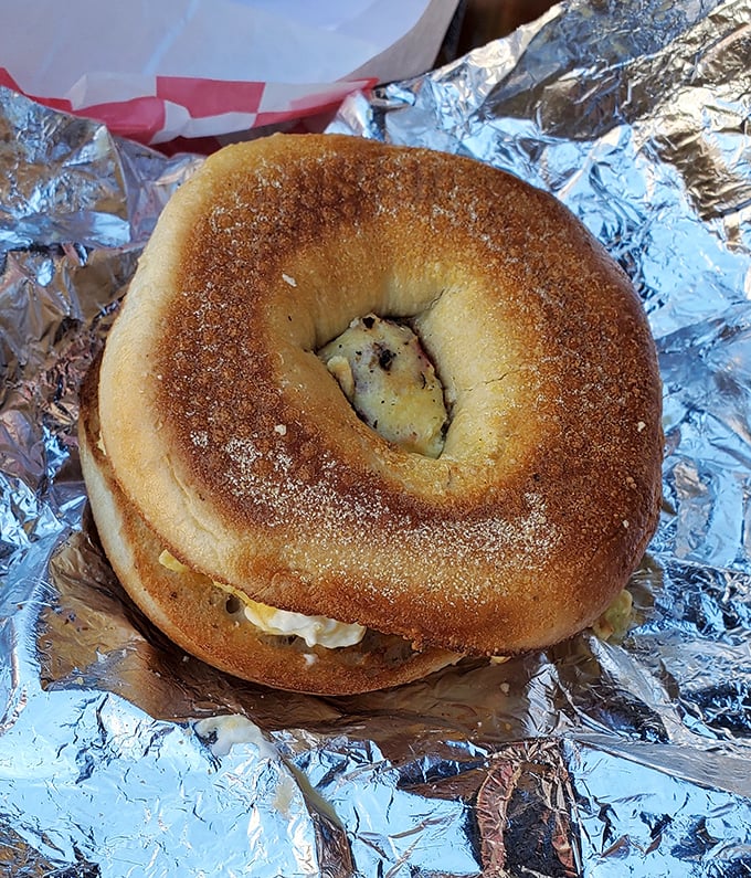The humble bagel – transformed from breakfast staple to canvas for creamy, savory masterpieces that make morning meetings almost bearable.